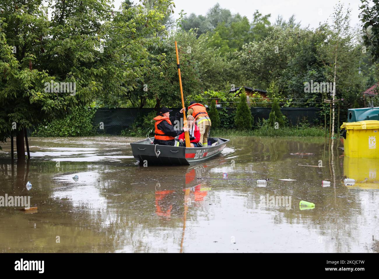 Firefighters are swimming on a boat after streets and households areas ...