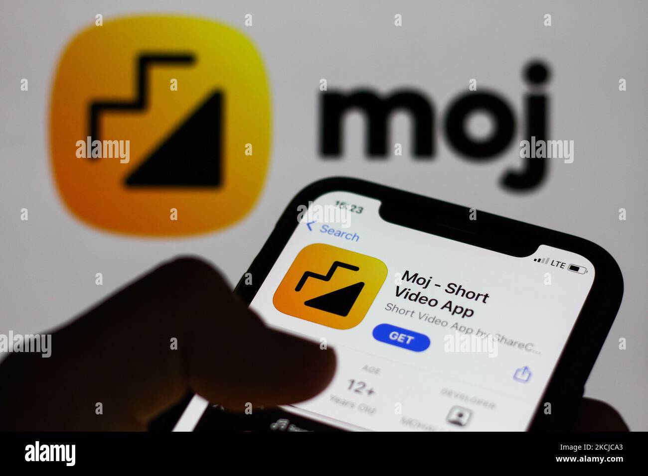 Moj logo on the App Store displayed on a phone screen and Moj logo in ...