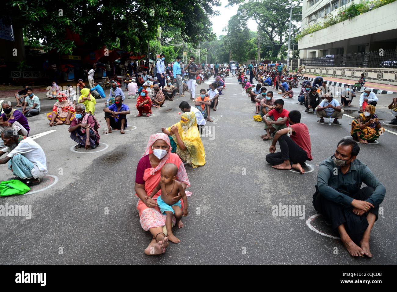 Poor people queue sit waits for receive food from Dhaka Metropolitan ...