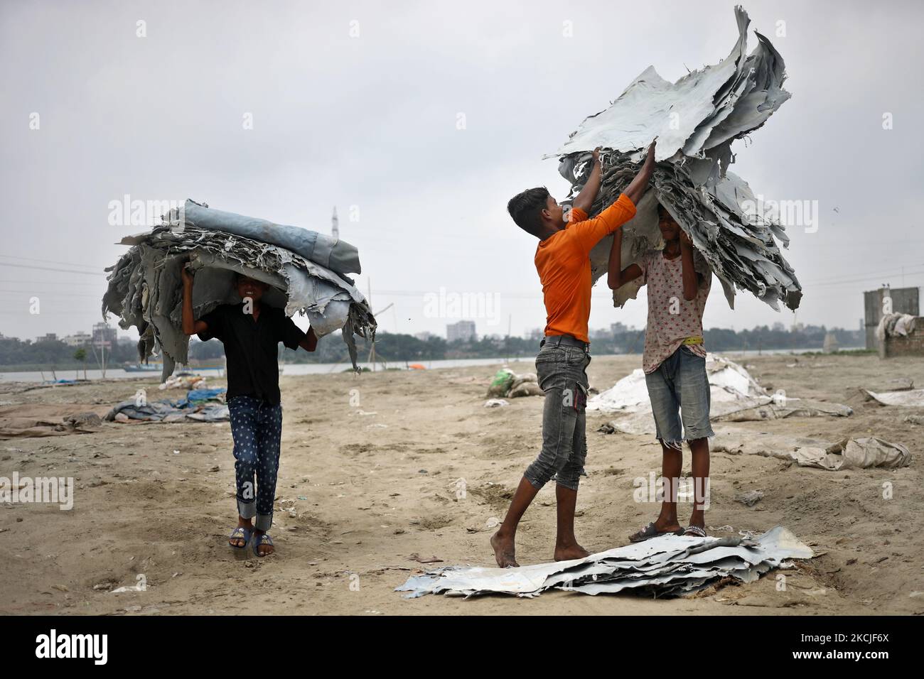 Child workers carry raw dry leather on a van to shift at a wirehouse ...
