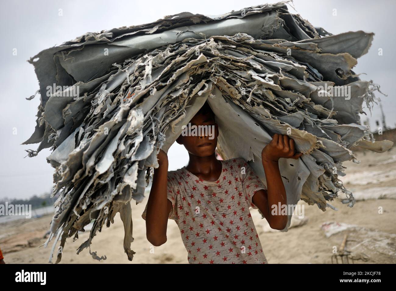 Child worker carries raw dry leather to shift at a wirehouse for ...