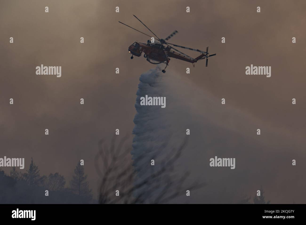 Firefighters continue to tackle a wildfire near the village of ...