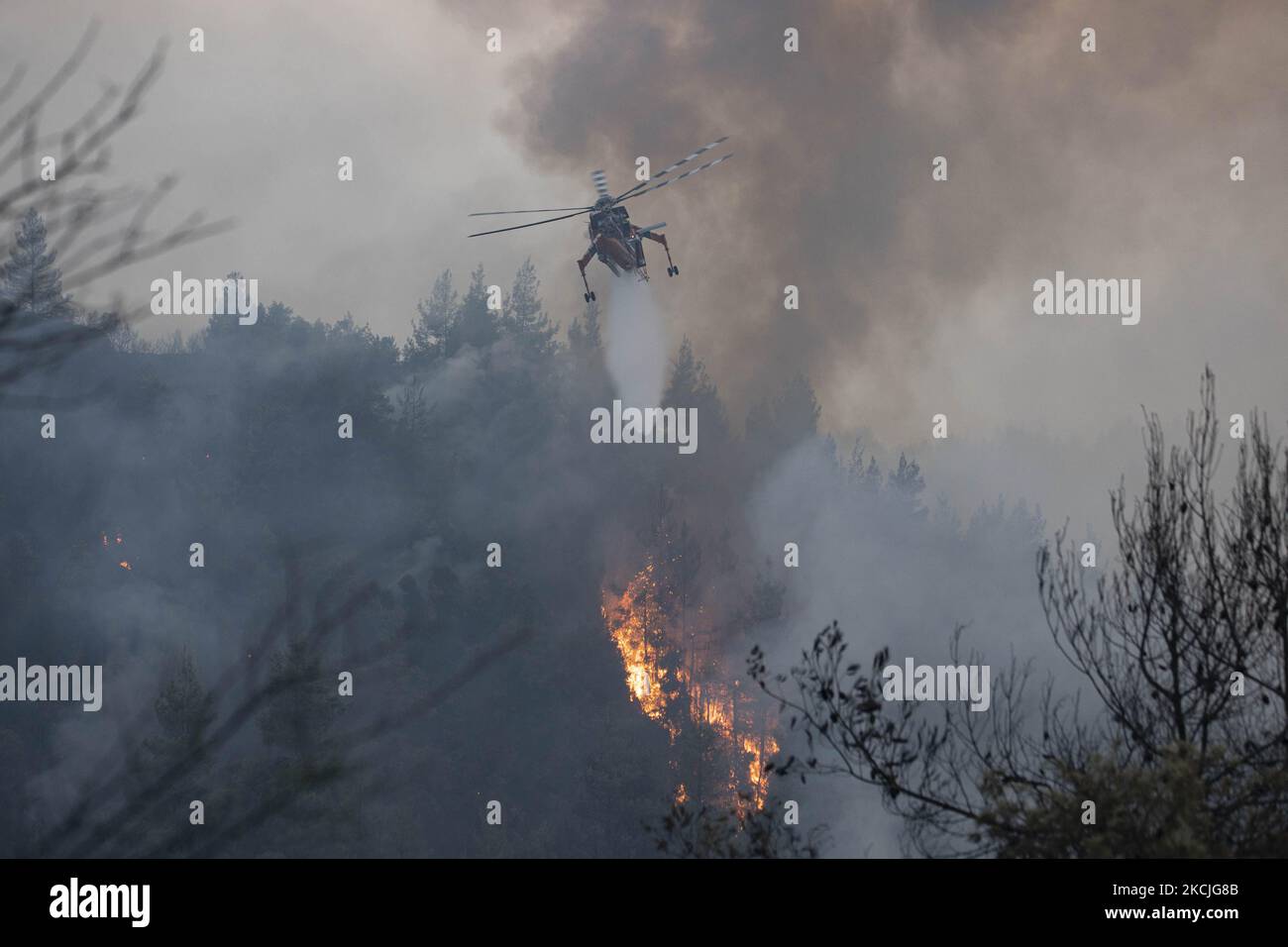 Firefighters continue to tackle a wildfire near the village of ...