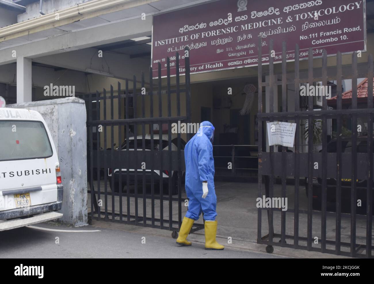 Sri Lankan health workers wearing PPE kits stand next to the Institute ...