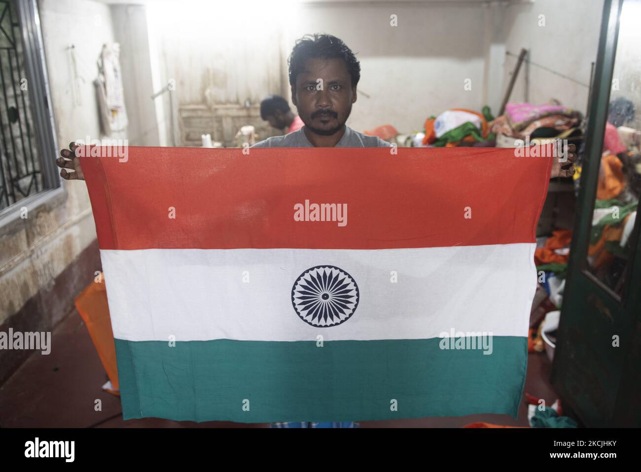 A worker shows a ready National Flag in a workshop. As the workers are ...