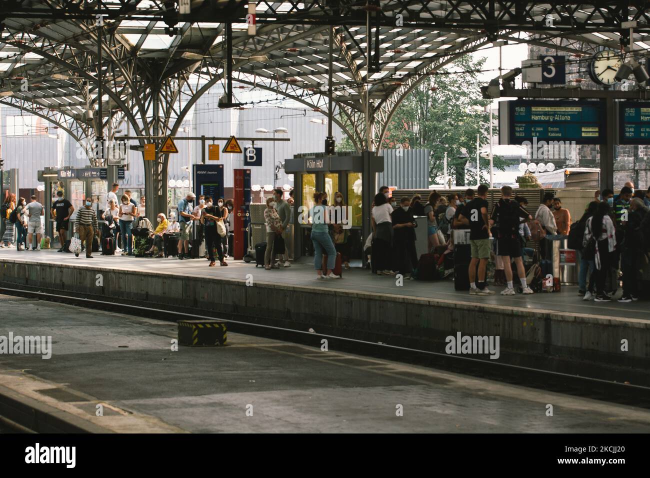 people wait for the train on the platform of Cologne messe station in ...