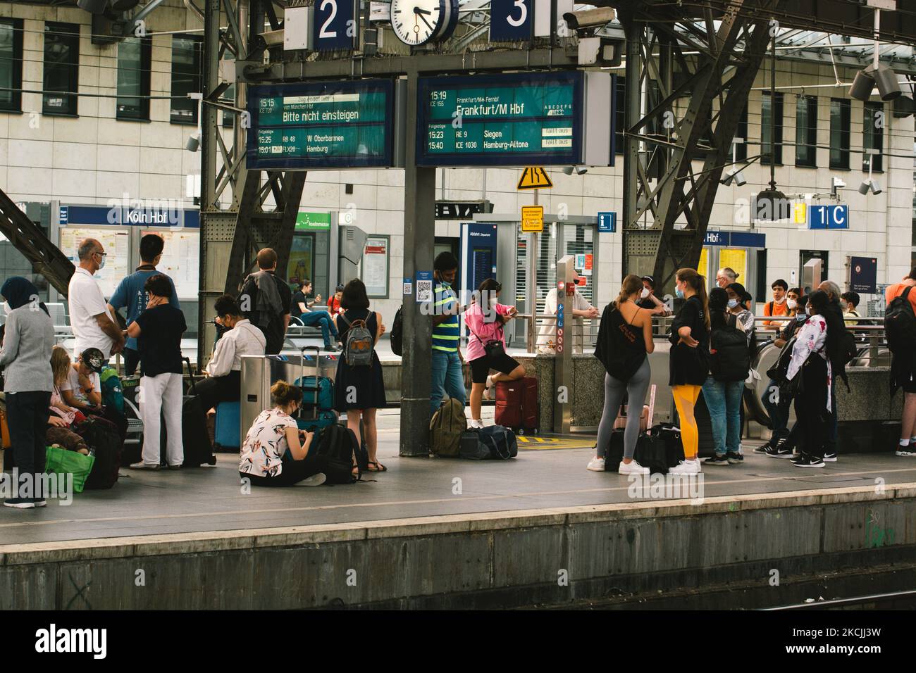 people wait for the train on the platform of Cologne messe station in ...