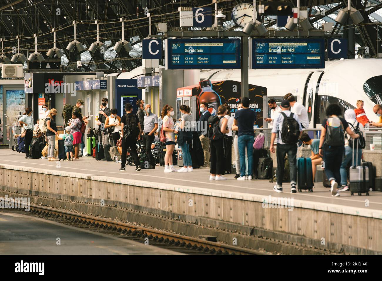 people wait for the train on the platform of Cologne messe station in ...