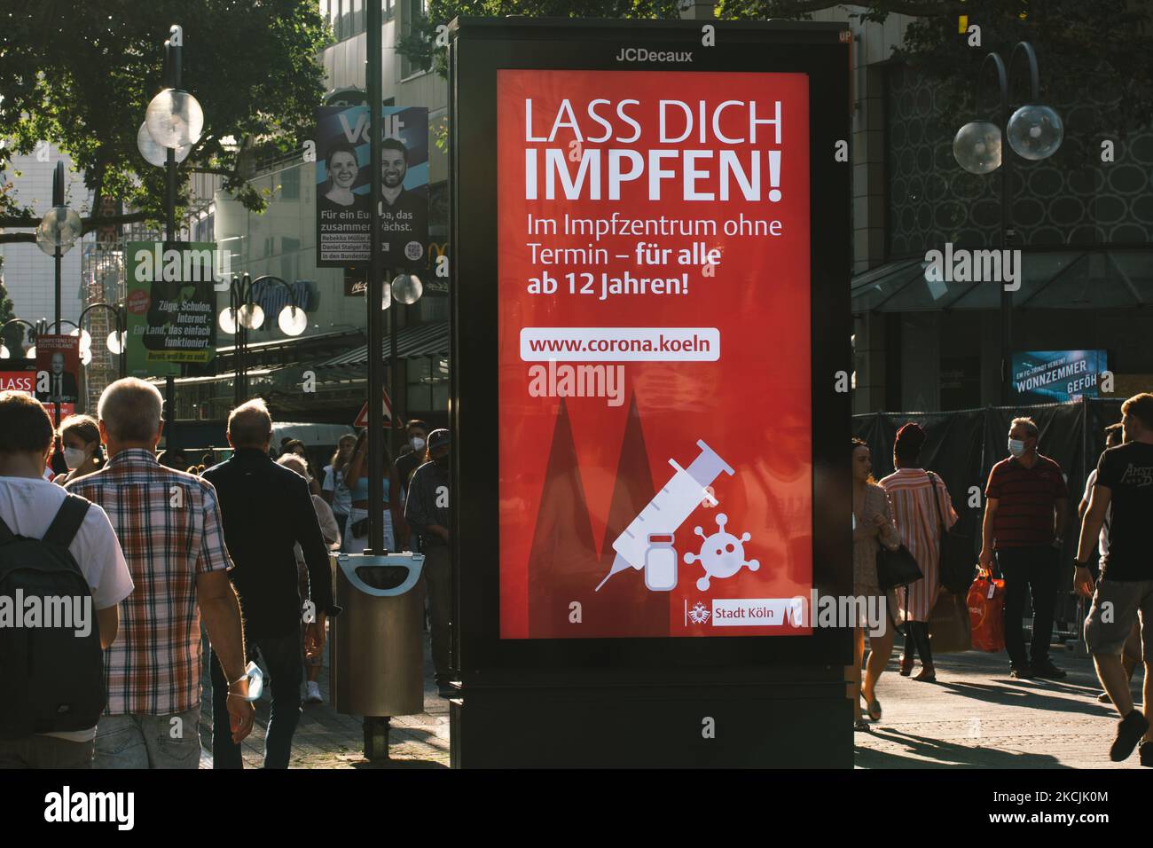 vaccination for youth information screen is seen in the city center of Cologne, Germany on ...