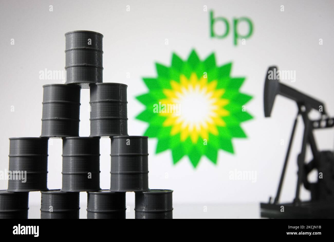 BP (British Petroleum) logo and miniature models of an oil derrick pump ...