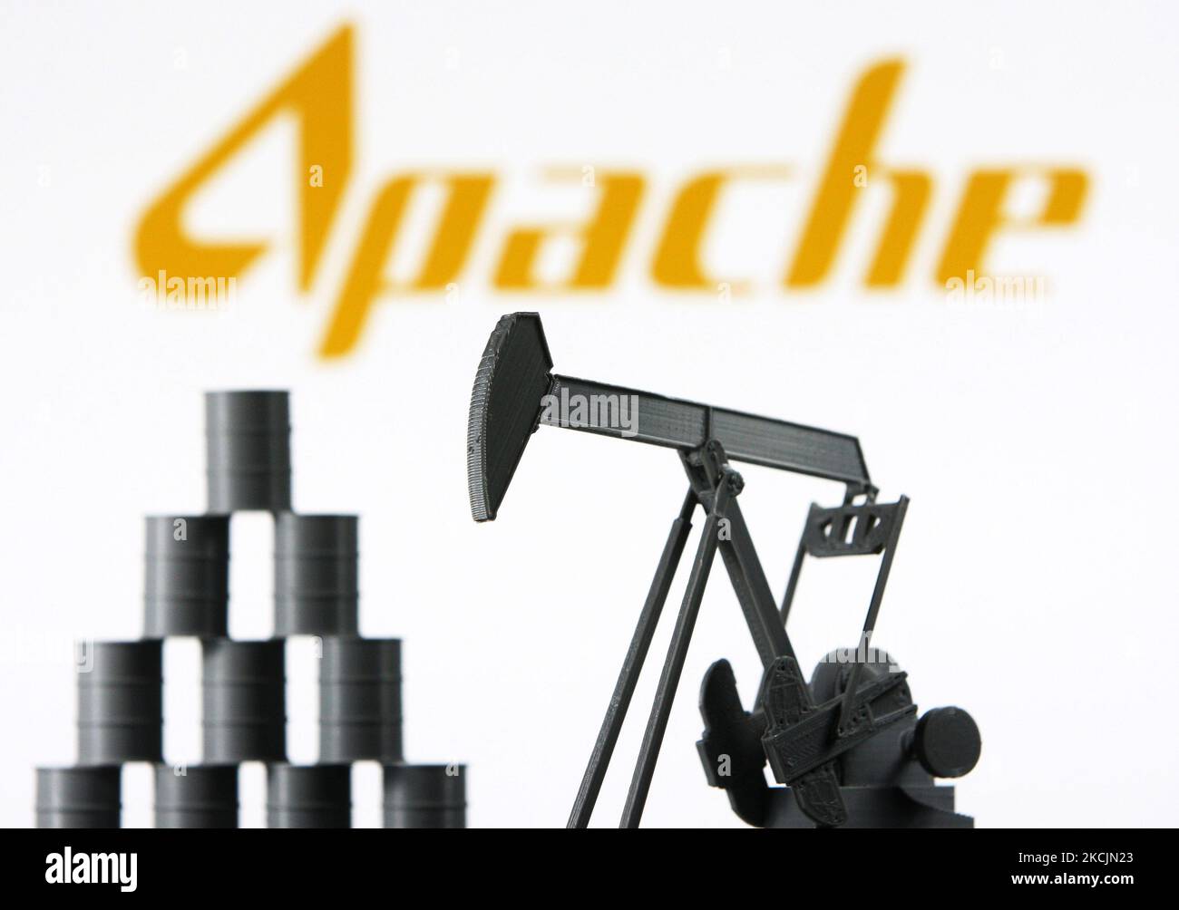Apache Corporation logo and miniature models of an oil derrick pump and ...