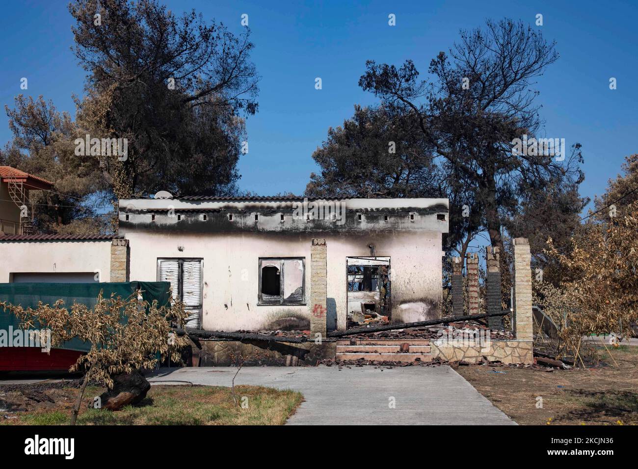 Burned house in Agia Anna. The aftermath of the fires in Greece, while ...