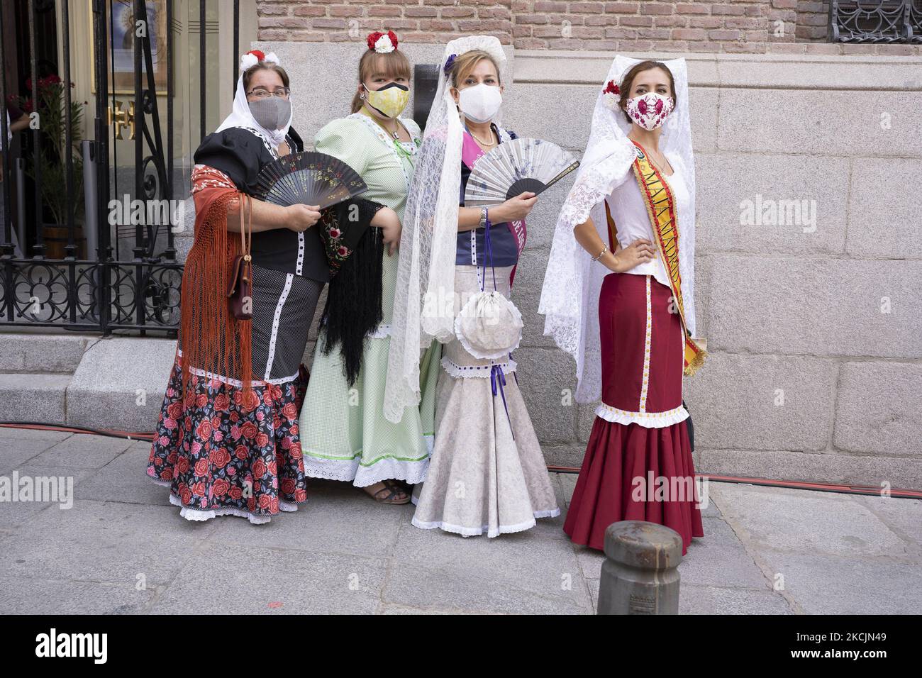 Women dressed in the typical costume of Chulapas attend a Eucharist on ...