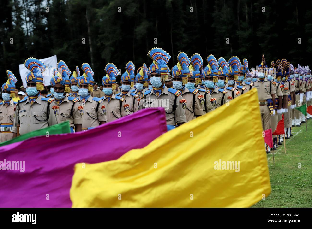 A Contigent of Indian Policemen stand in formation at Khushal Stadium ...