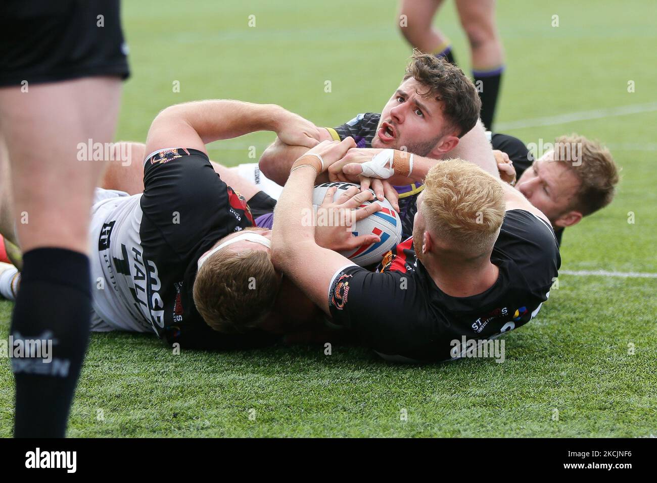 Jack Johnson of Newcastle Thunder is held up over the try line during ...