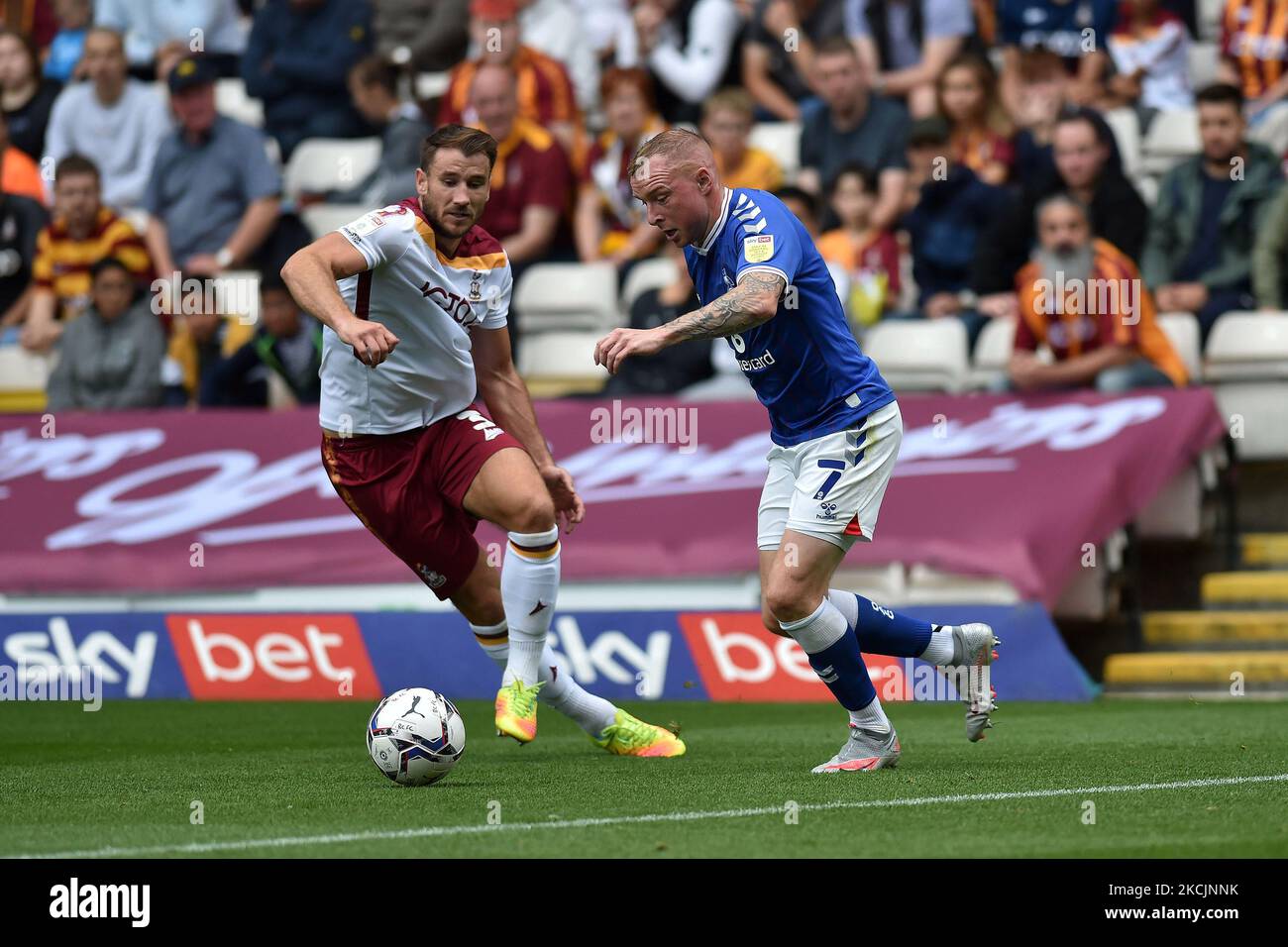 Oldham Athletic's Nicky Adams tussles with Liam Ridehalgh of Bradford ...