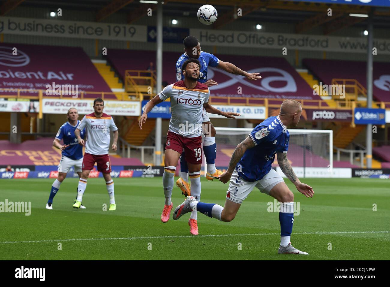 Oldham Athletic's Jordan Clarke tussles with Lee Angol of Bradford City ...
