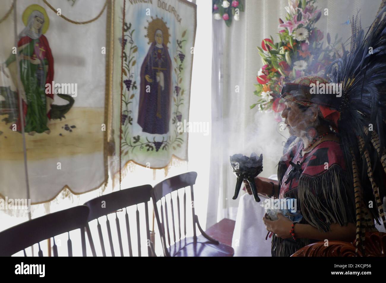 A pre-hispanic dancer performs a ritual with incense and copal on an ...