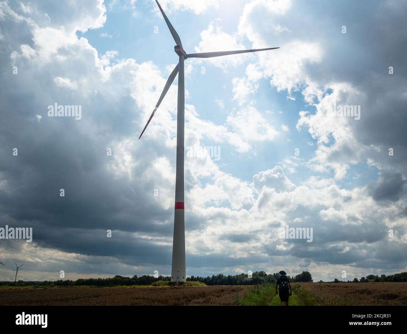 A man is walking under a windmill, during the new route, The Dutch ...