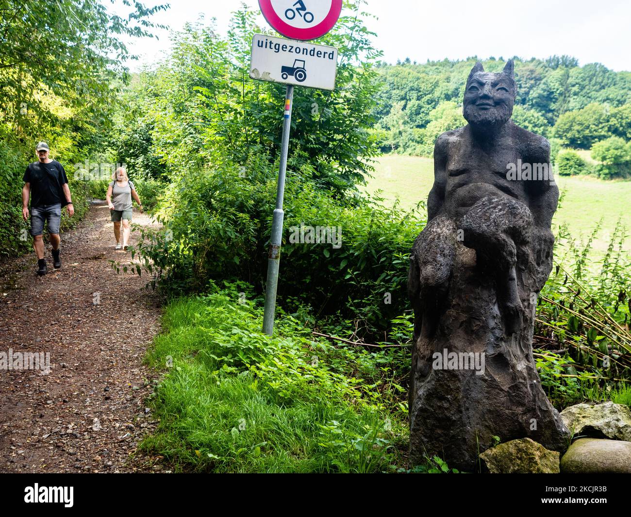 A couple is walking close to a devil statue, during the new route, The ...