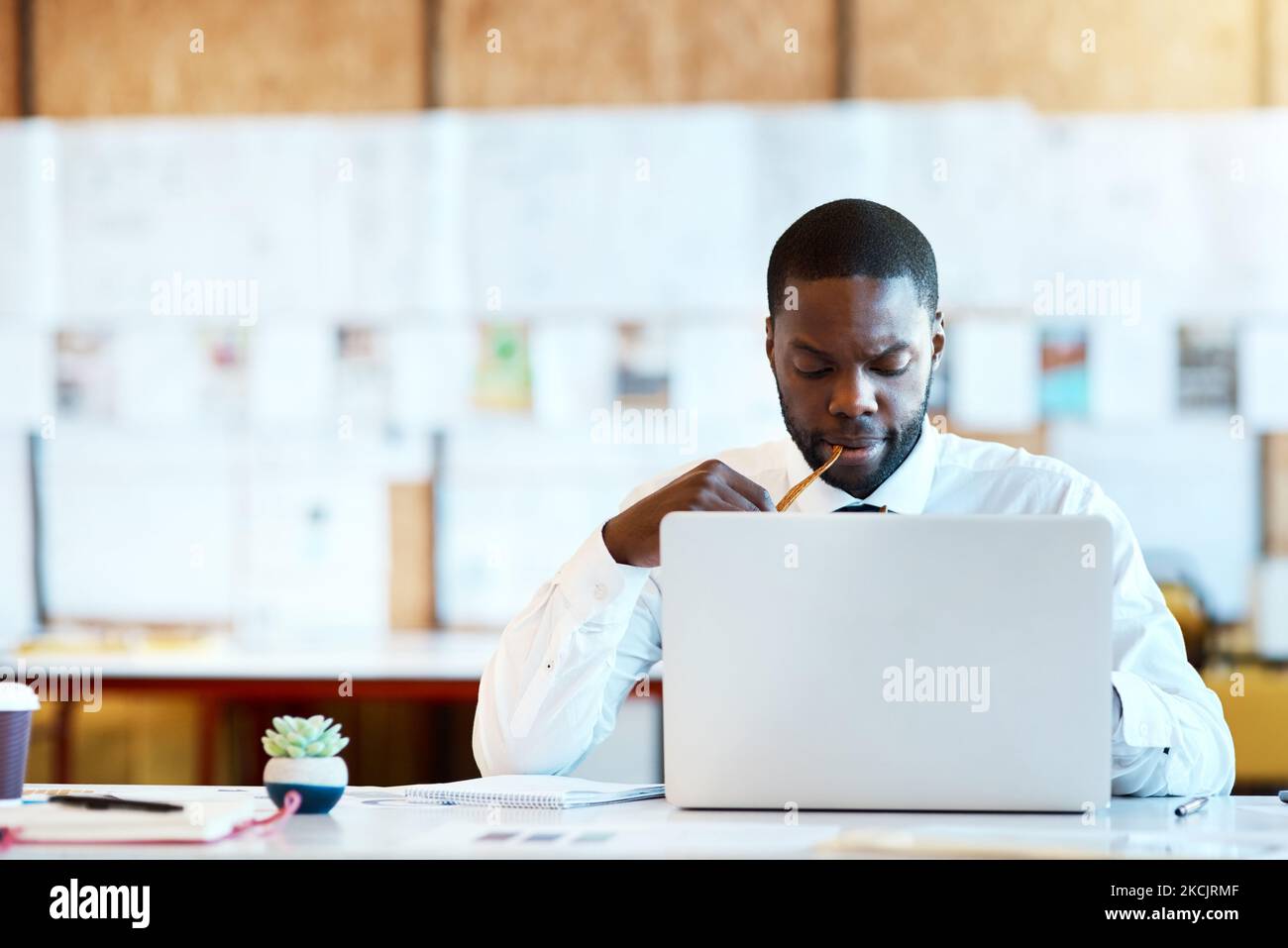 The thinking process continues. a focused young businessman typing on ...