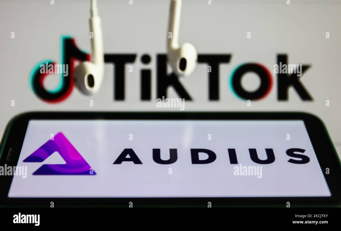 Audius logo displayed on a phone screen, TikTok logo displayed on a ...