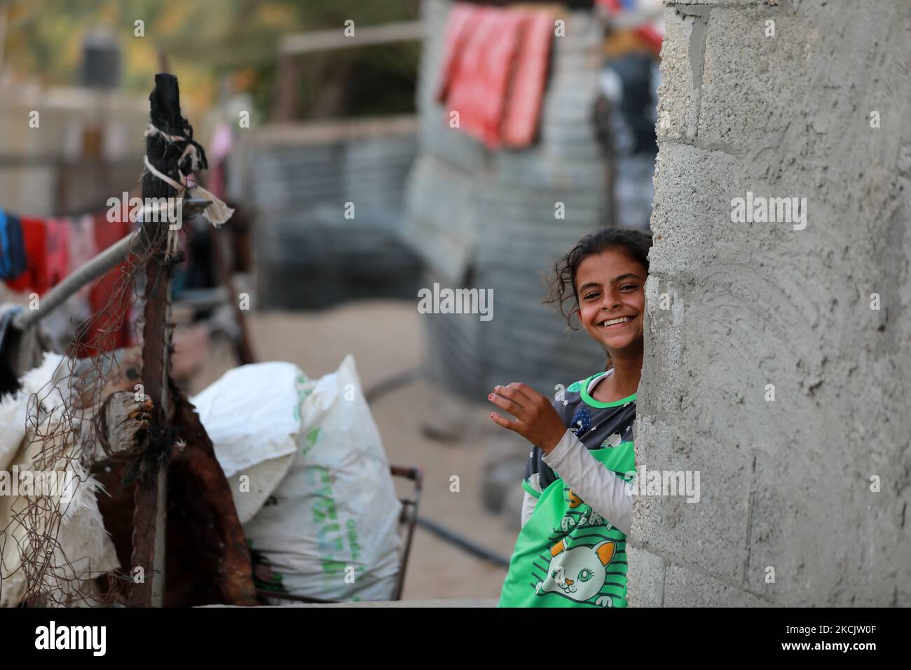 A Palestinian girl plays outside her house in a slum on the outskirts ...