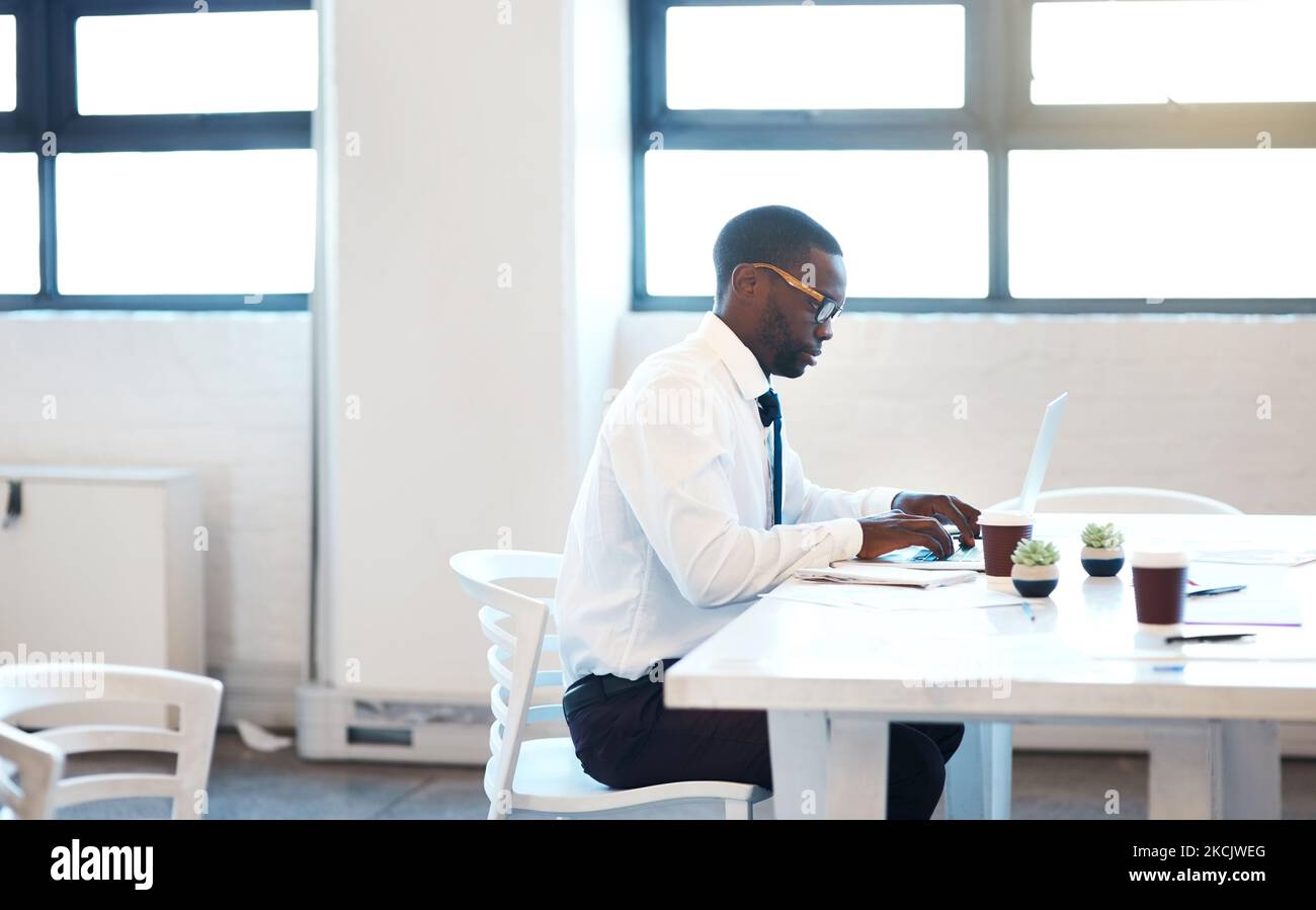 Nothing can break his focus. a focused young businessman typing on his ...