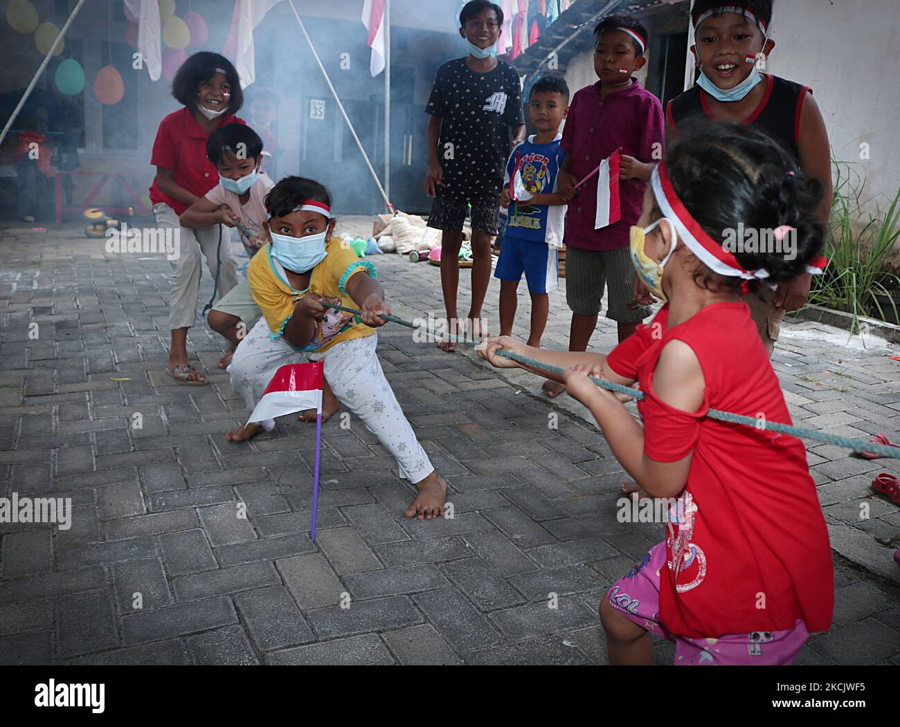 several children competing in the traditional child game (pull the roop ...