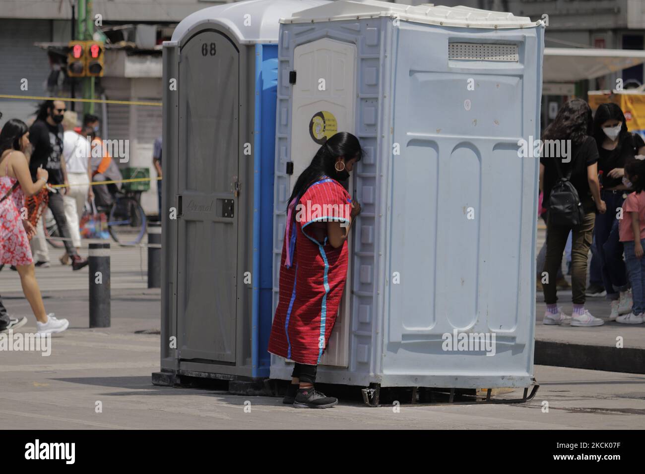 A woman from the indigenous Triqui community waits to enter a public ...