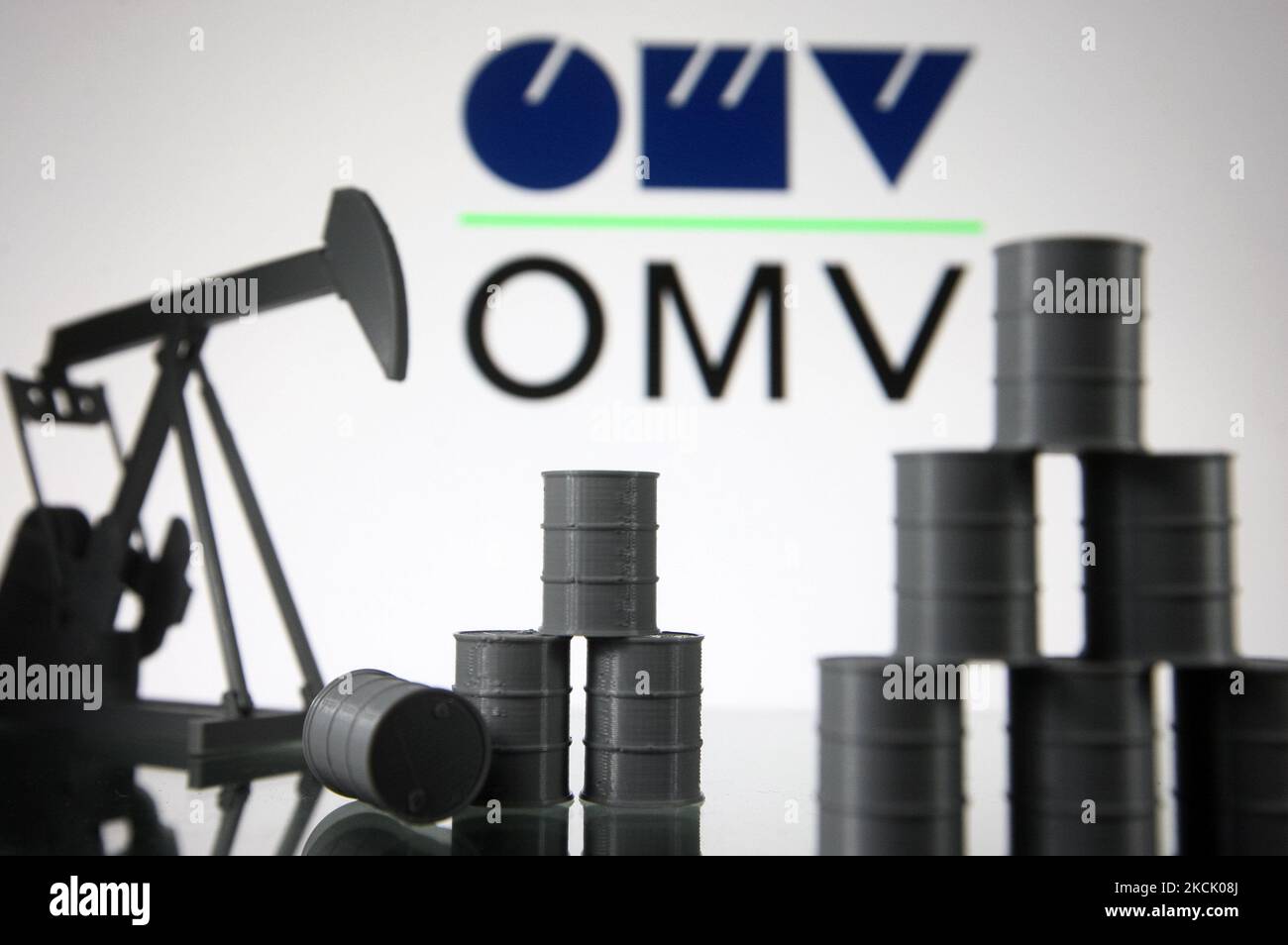 OMV logo and models of an oil derrick pump jack and oil barrels are ...