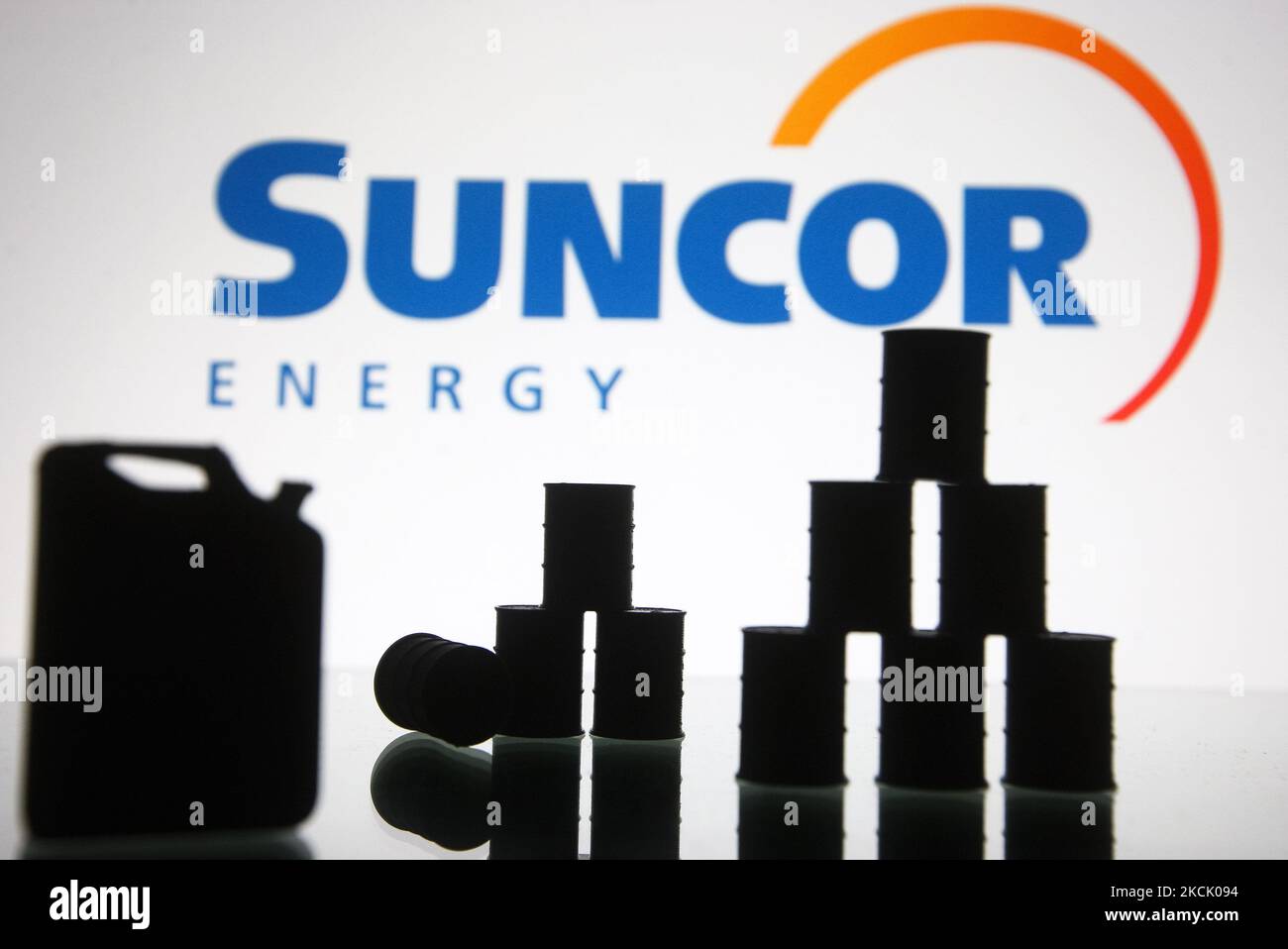 Suncor Energy logo and models of a fuel ?an and oil barrels are ...