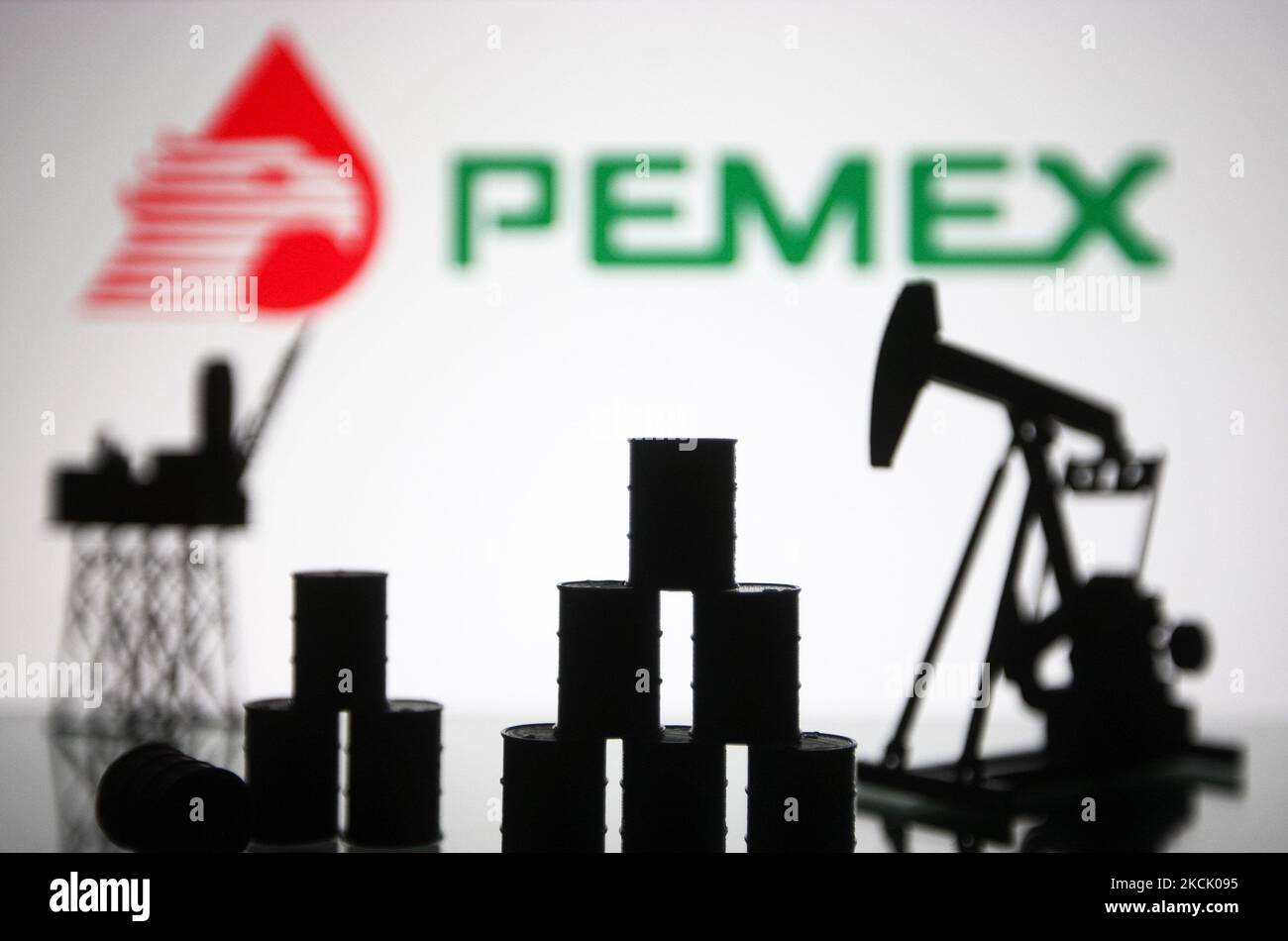 Pemex logo and models of an oil rig, pump jack and oil barrels are ...