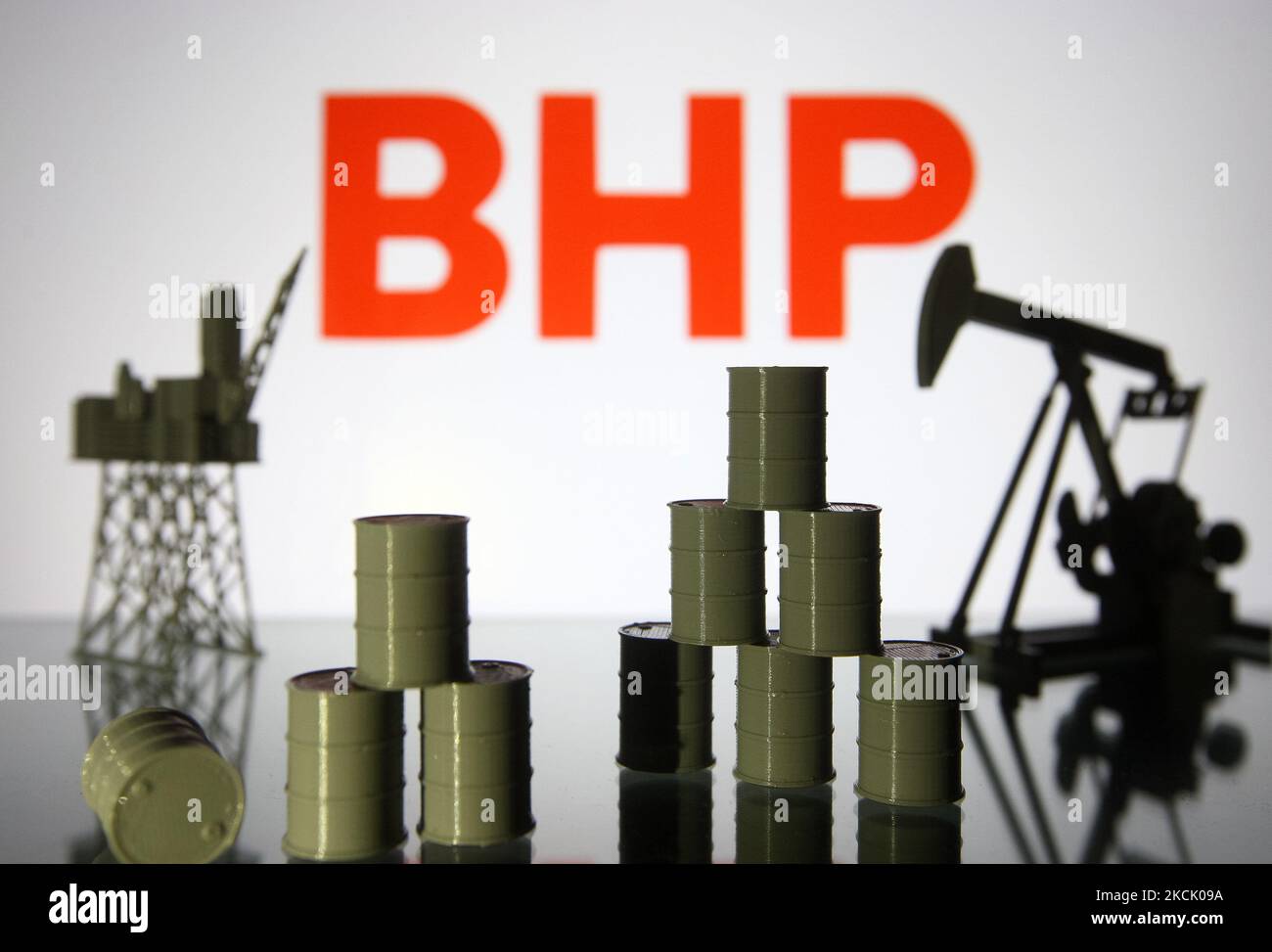 BHP logo and models of an oil rig, pump jack and oil barrels are ...