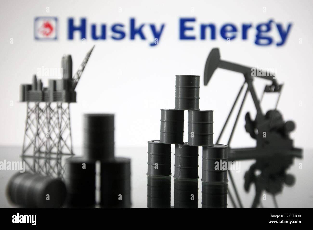 Husky Energy logo and models of an oil rig, pump jack and oil barrels ...