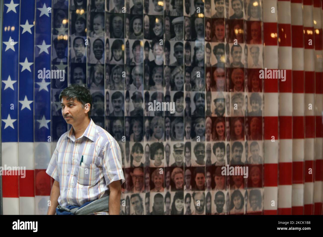 Tourist stands in front of an exhibit featuring a hologram of a large ...