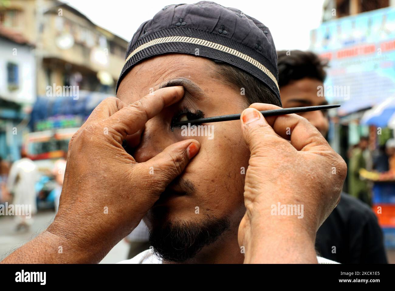Afghan man is wearing surmah in his eyes as they attend a procession to ...
