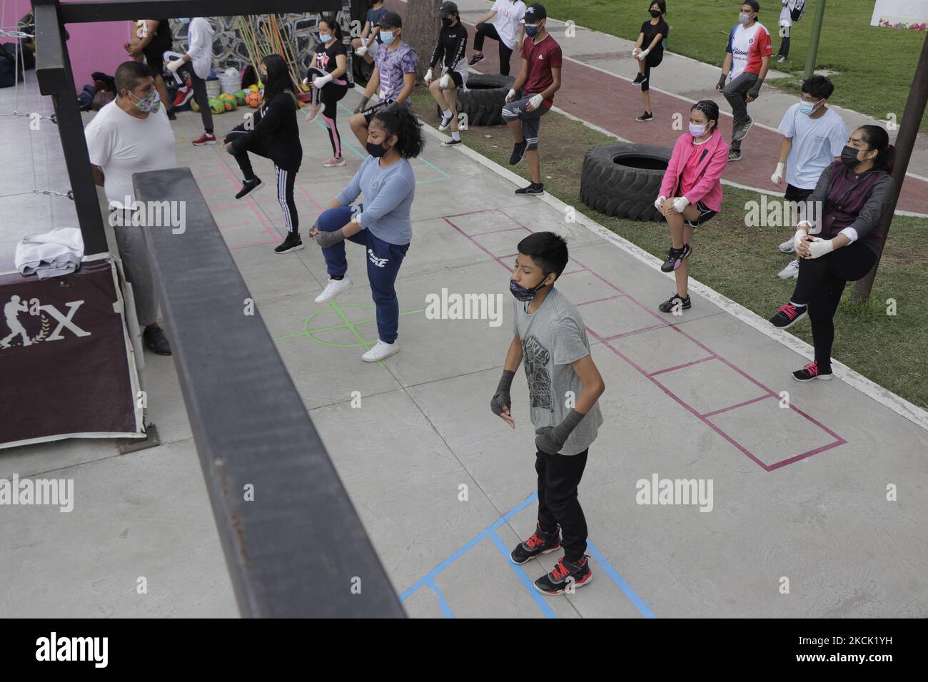 A group of young people attend boxing and fitness classes taught by ...