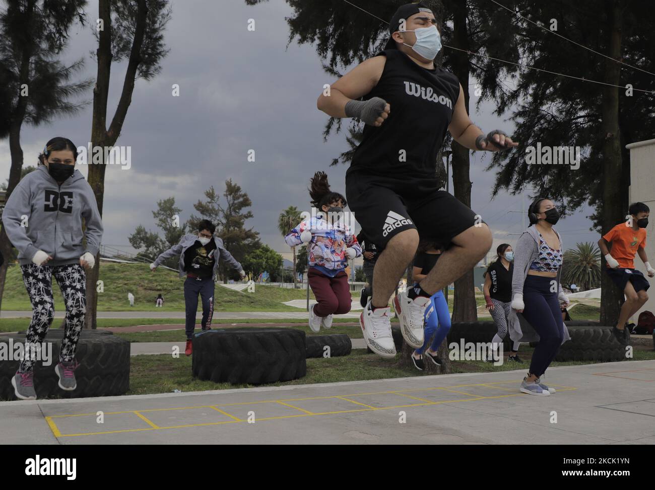A group of young people jump in boxing and fitness classes at UTOPÍA ...