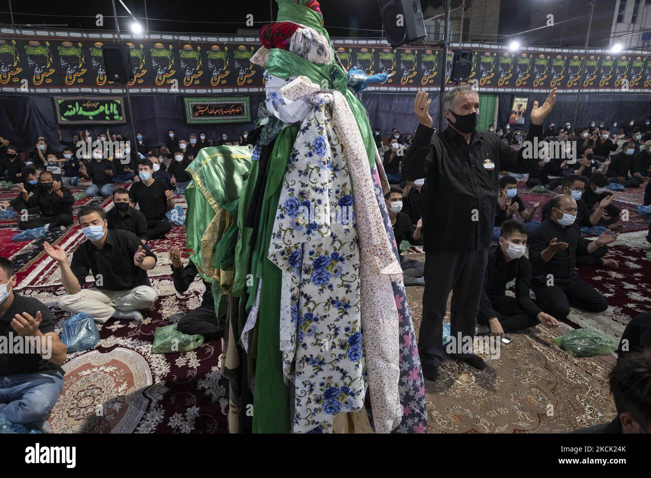 Afghan refugee men wearing protective face masks pray for peace and ...