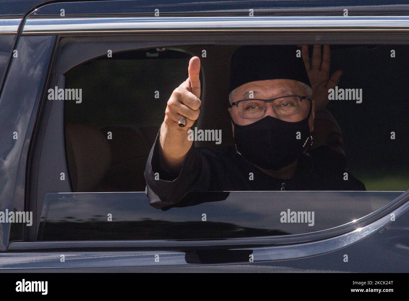 New Malaysian Prime Minister Ismail Sabri Yaakob waves from a car, as ...