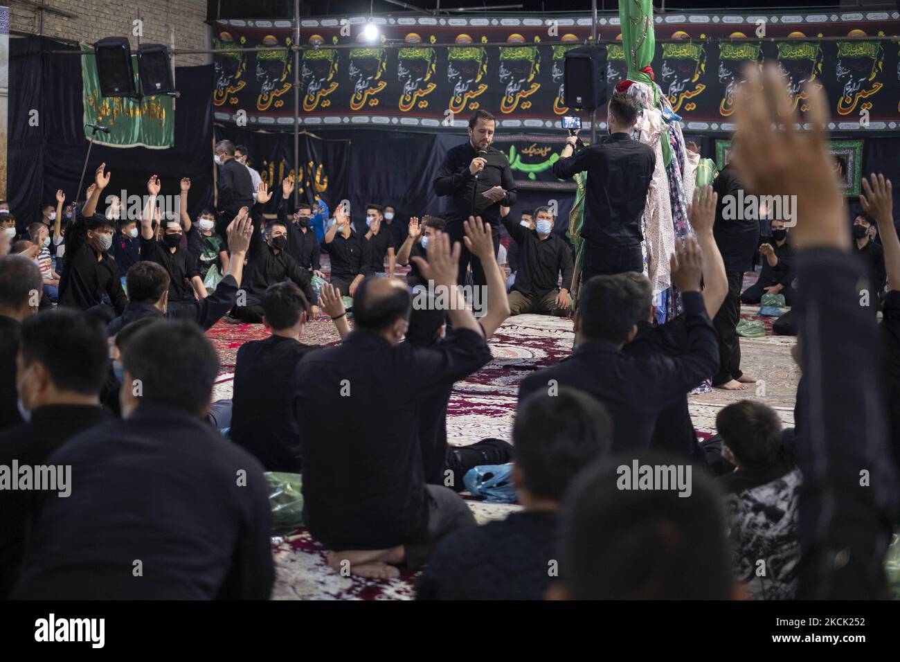 Afghan refugee men wearing protective face masks pray for peace and ...
