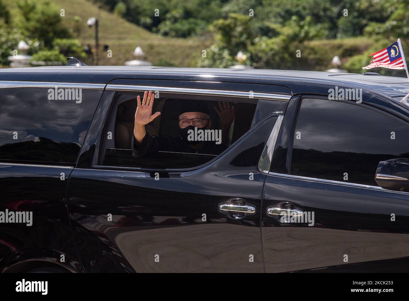 New Malaysian Prime Minister Ismail Sabri Yaakob waves from a car, as ...