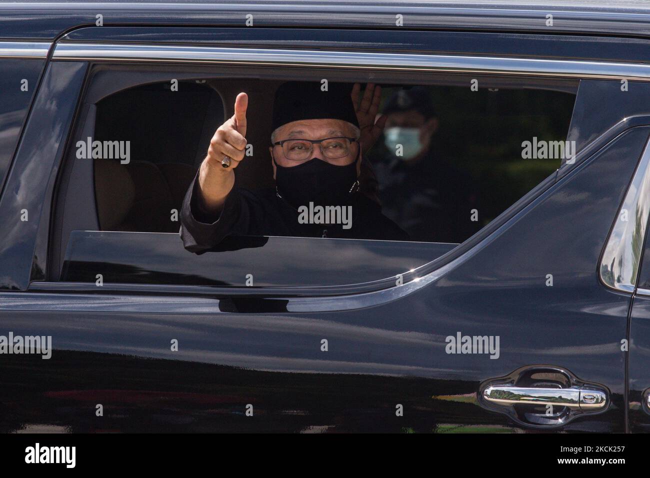 New Malaysian Prime Minister Ismail Sabri Yaakob waves from a car, as ...