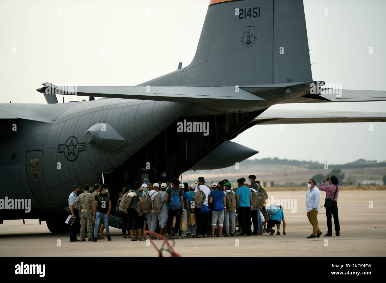 Afghan refugee queue to embark into a US air force plane at Torrejon ...