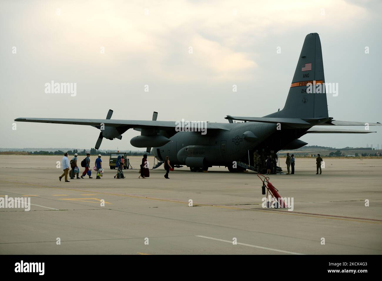 Afghan refugee queue to embark into a US air force plane at Torrejon ...