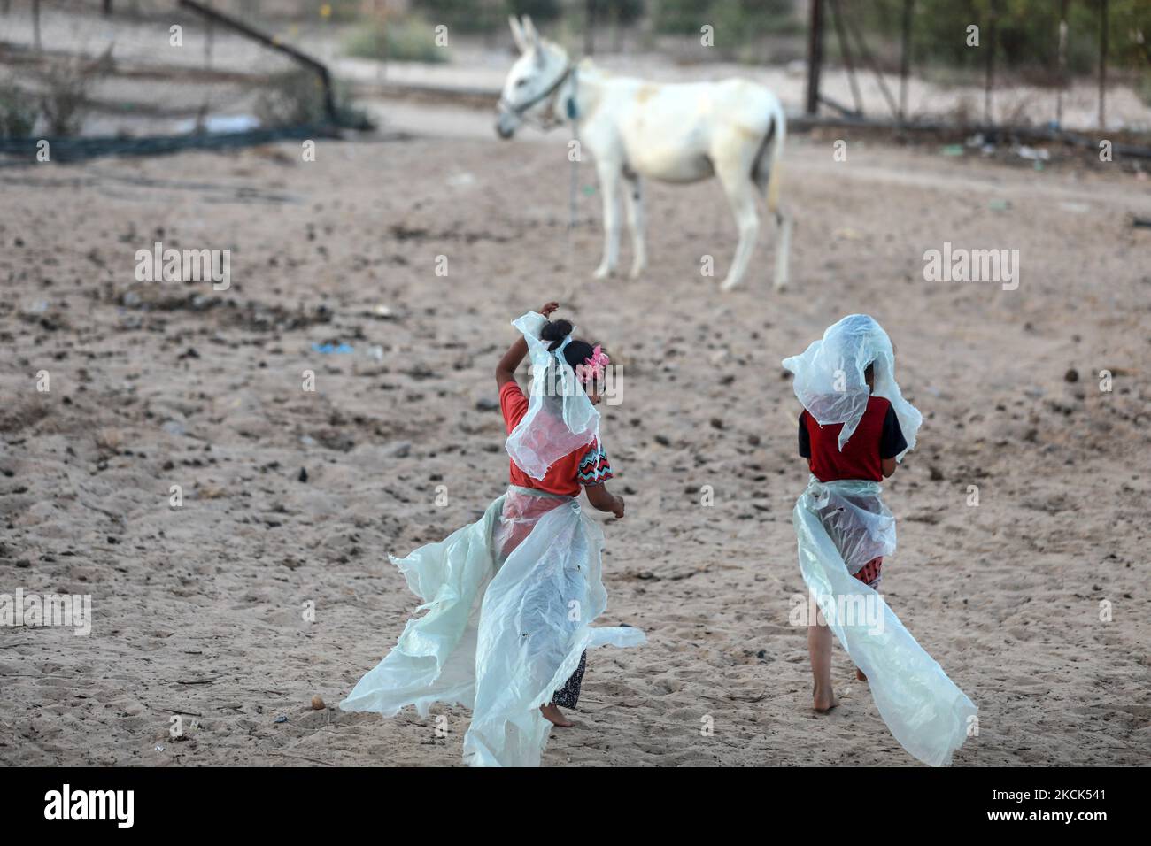 Palestinian girls play outside their home in a poor neighborhood west ...