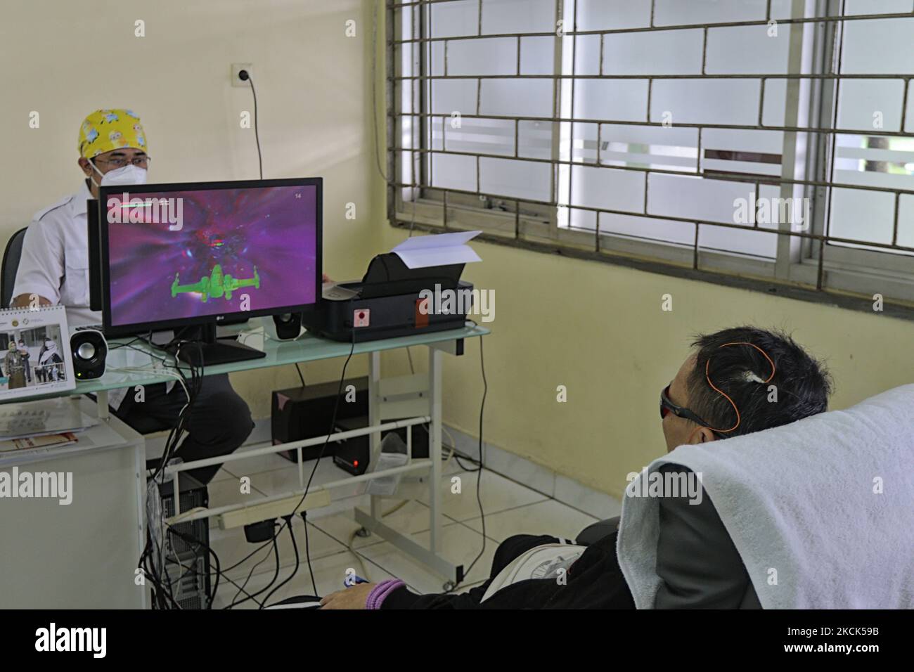A psychiatric rehabilitation patient while undergoing neurofeedback ...