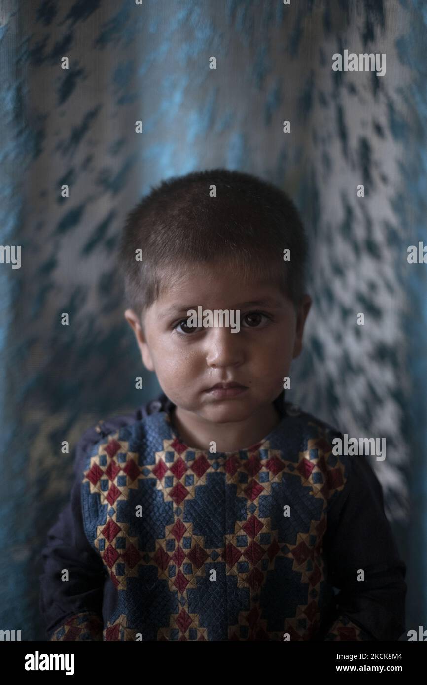 An Afghan refugee young boy, Ahmad-2 who has escaped from his hometown ...