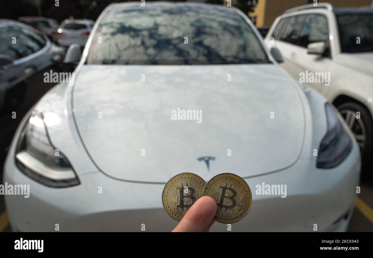 Illustrative image of two commemorative bitcoins seen in front of the ...